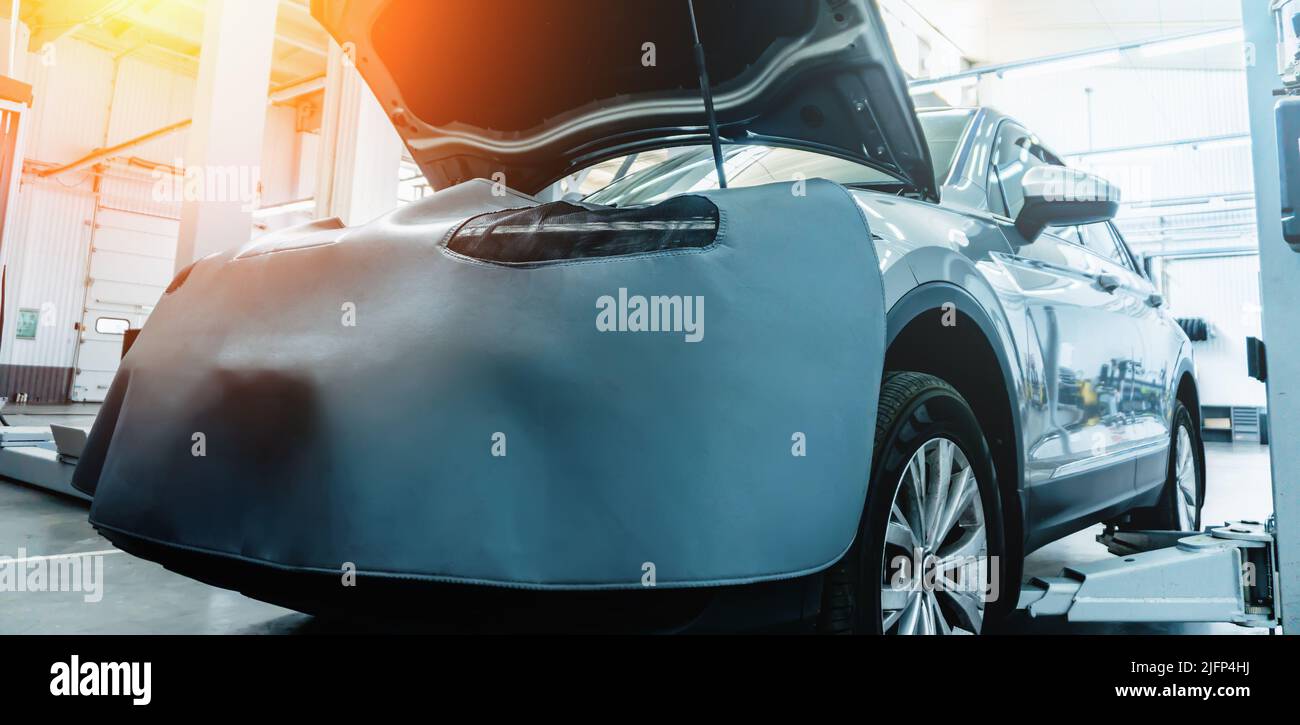 Car in car service garage with open hood. Auto maintenance and repair ...