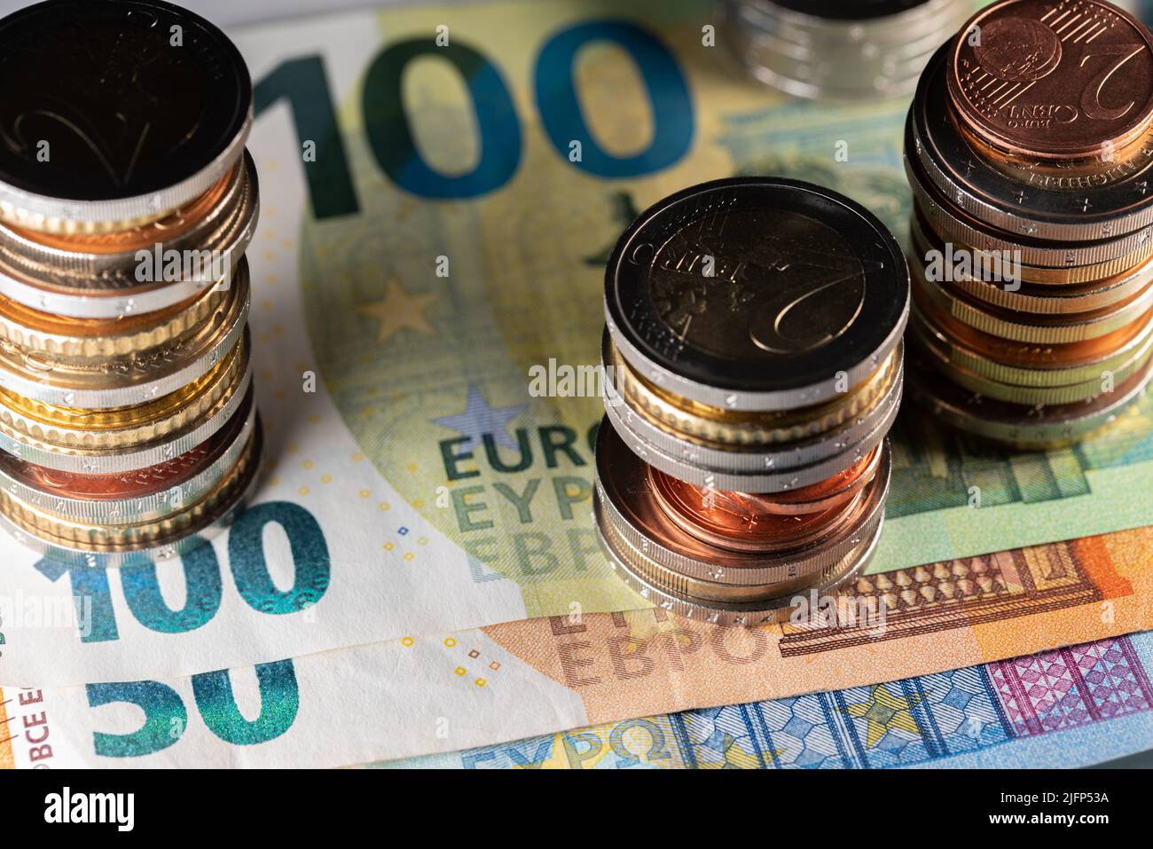Stack of euro coins on Euro banknotes and bills Stock Photo - Alamy