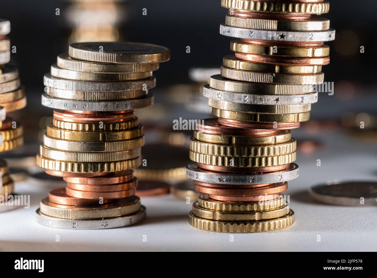 Stacked Coins of Euros, all Euro coins piled up and tilting to the ...