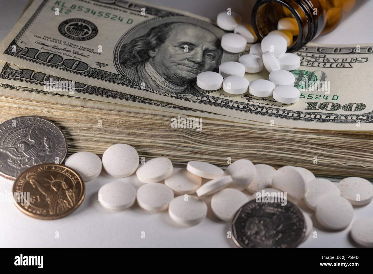 Cash and pills. Medicine and Money. Stack of 100 Dollar bills with ...
