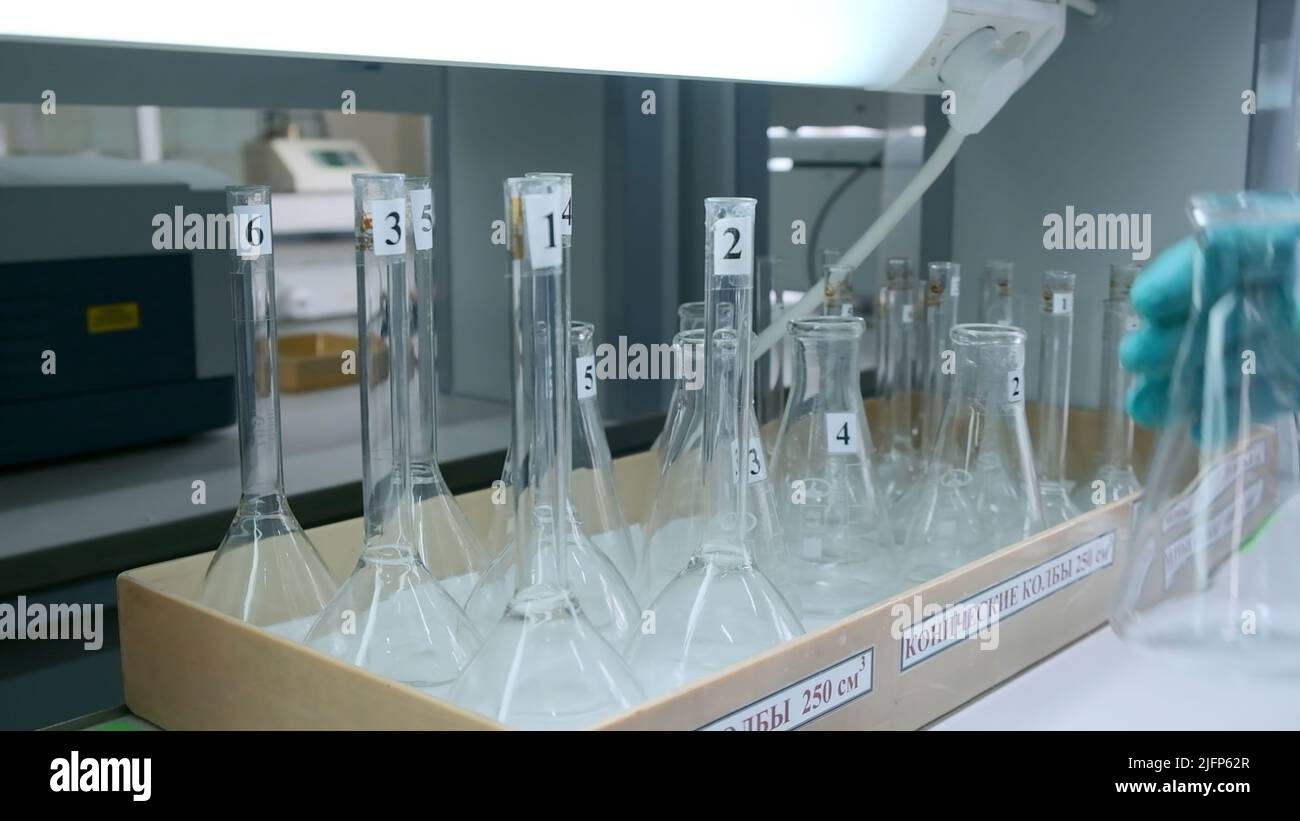 Chemical experiments.Clip. Various glass tubes in which solutions of ...