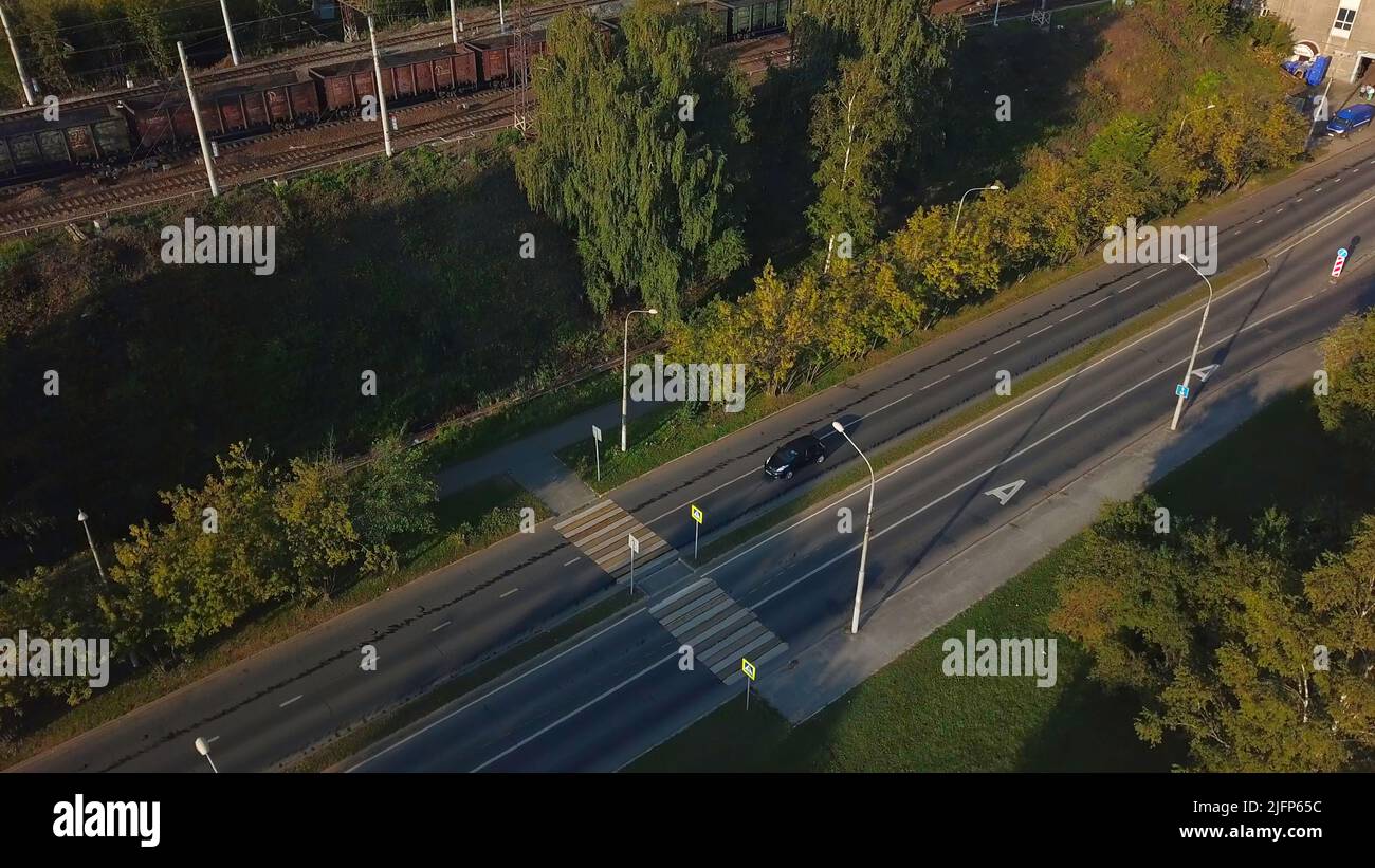 Top view of car driving along suburban highway on summer day. Clip ...