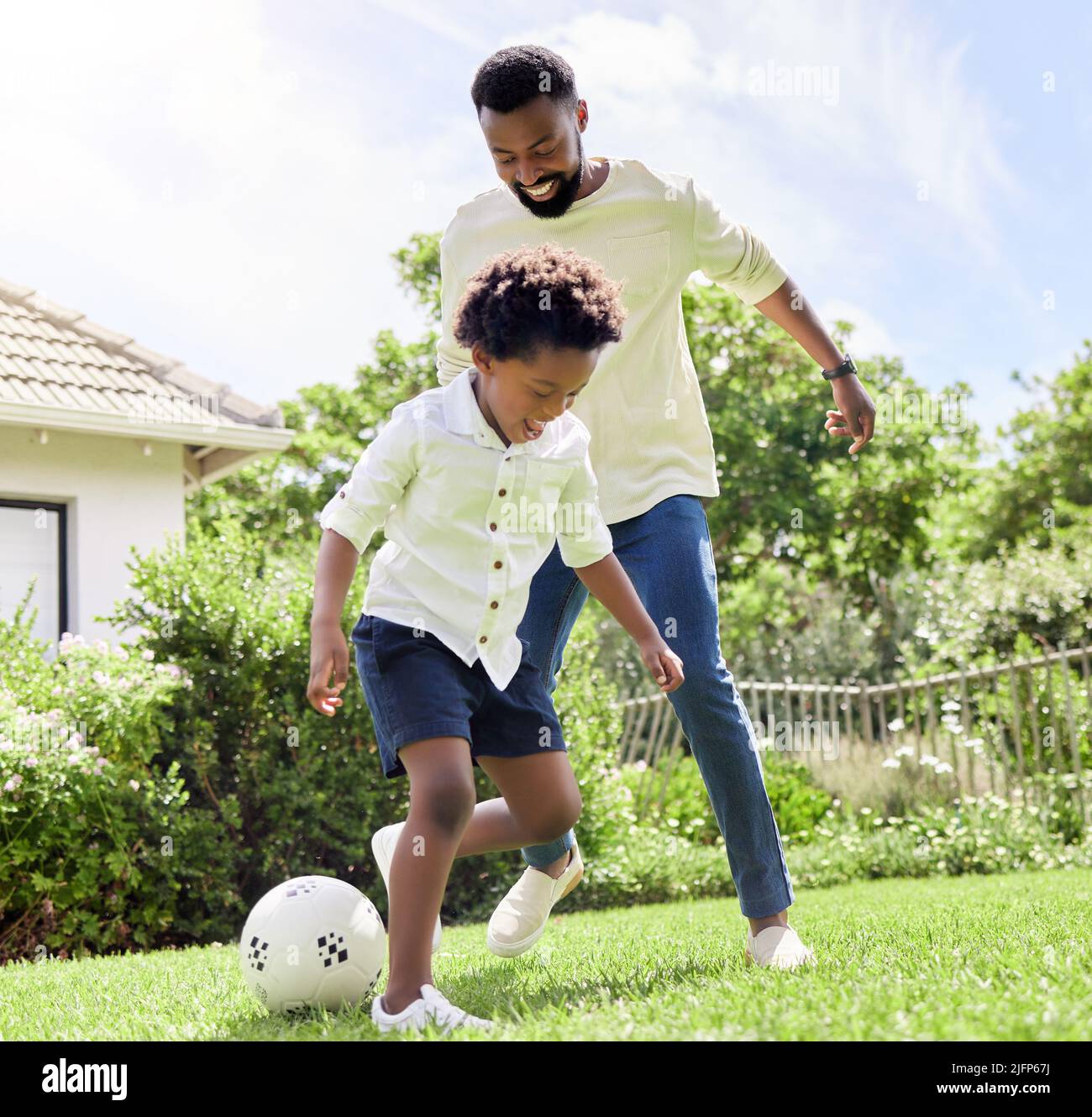 Boy playing soccer with dad hi-res stock photography and images - Alamy