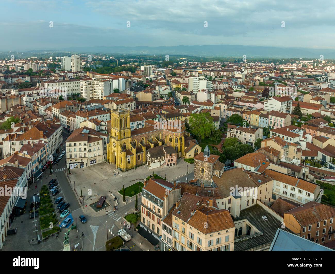 Aerial view of downtown Roanne in France with yellow church, old castle ...