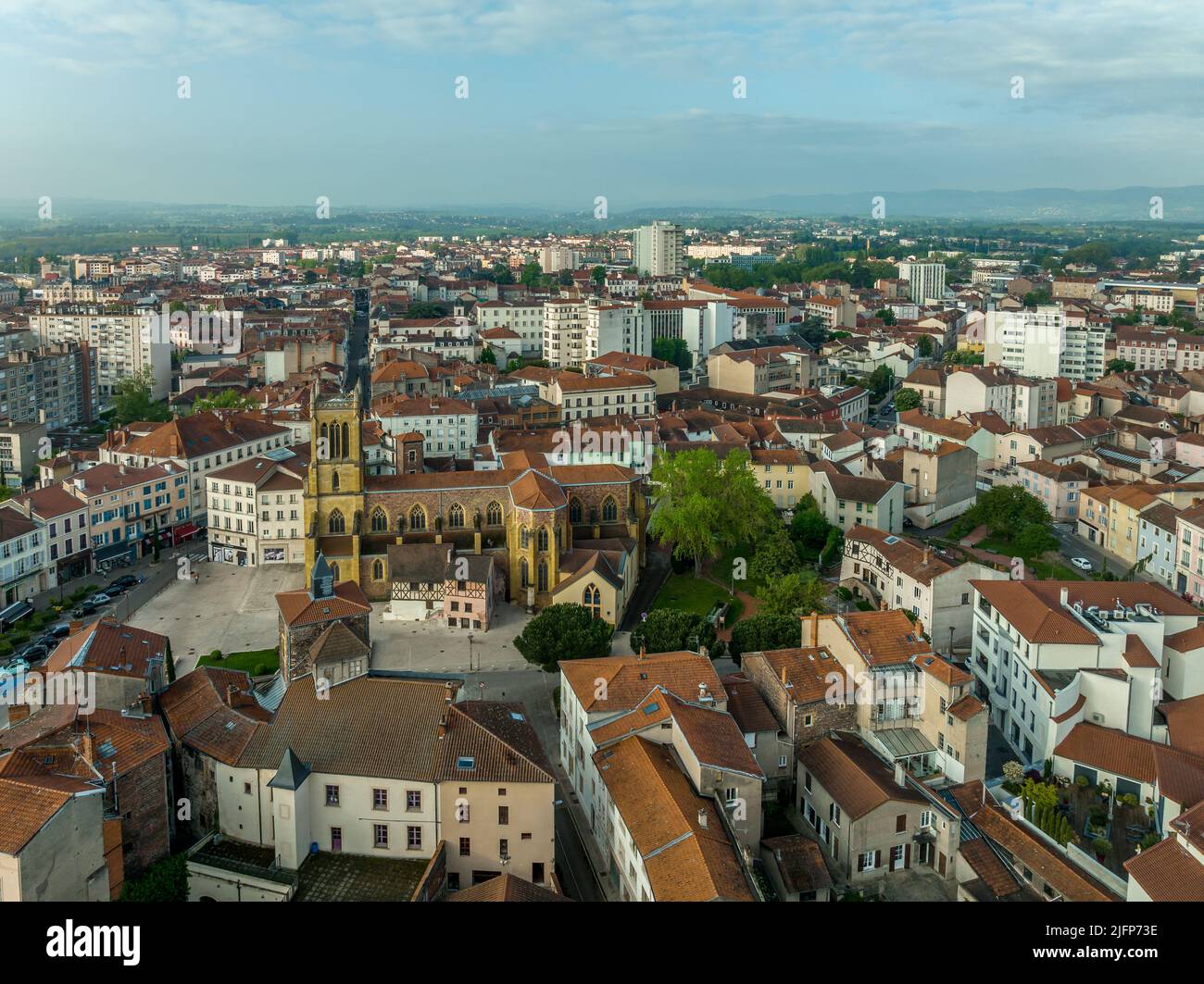 Aerial view of downtown Roanne in France with yellow church, old castle ...