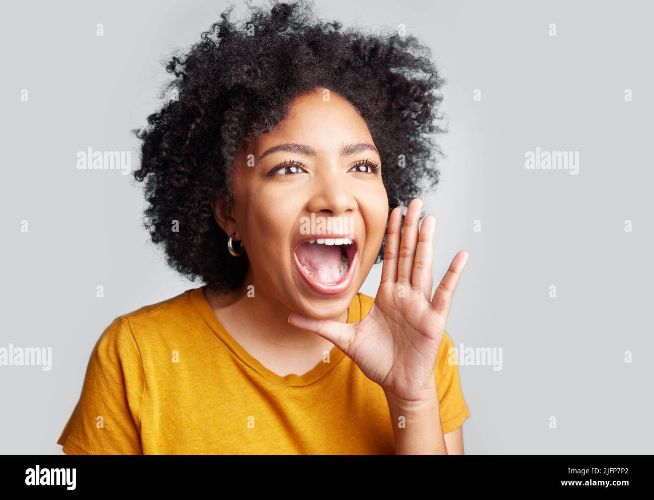 I can get a little loud. Studio shot of a woman screaming while ...