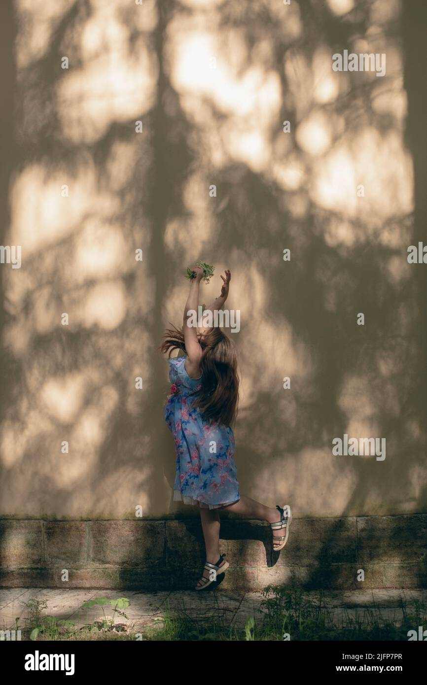 Shadow girl on an orange wall in summer Stock Photo - Alamy