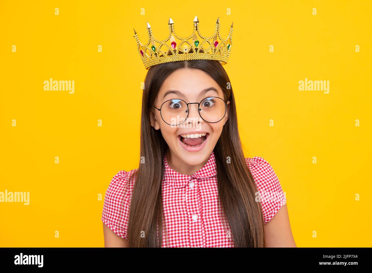 Amazed teen girl. Little queen wearing golden crown. Teenage girl ...