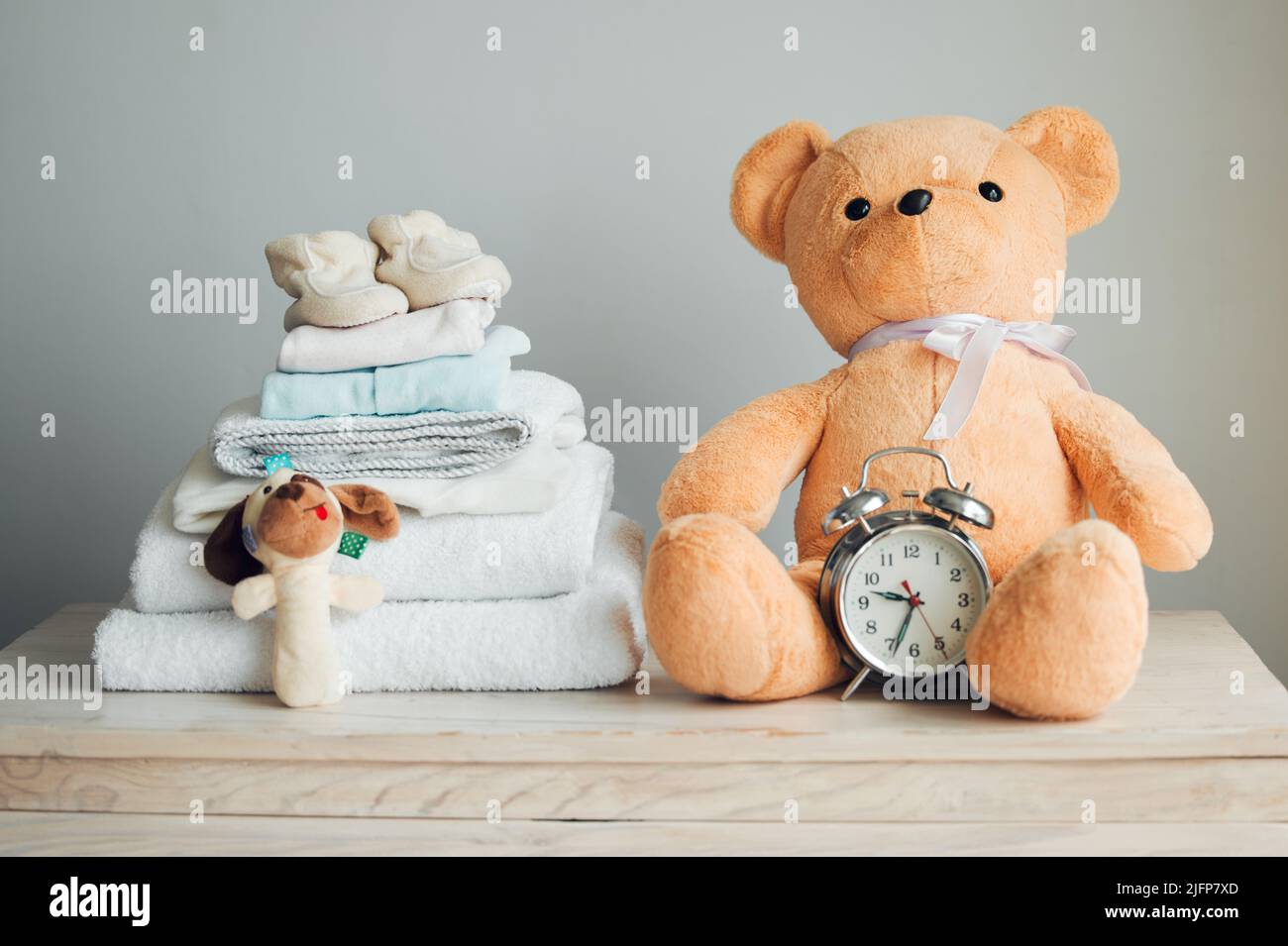 Prepared for their arrival. Shot of a teddy bear and baby blankets ...