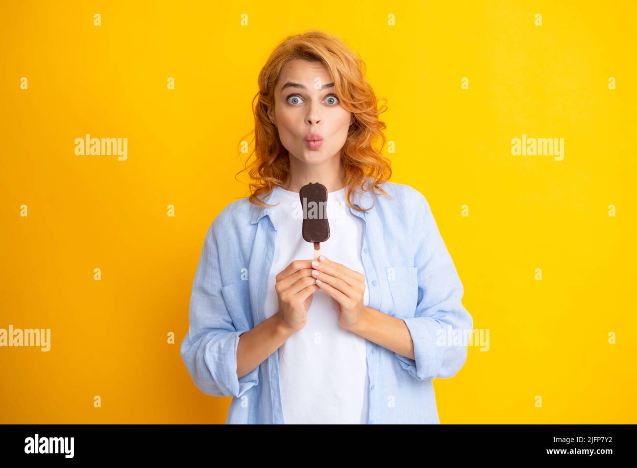 Portrait Of Beautiful Woman Eating Ice Cream On Orange Yellow