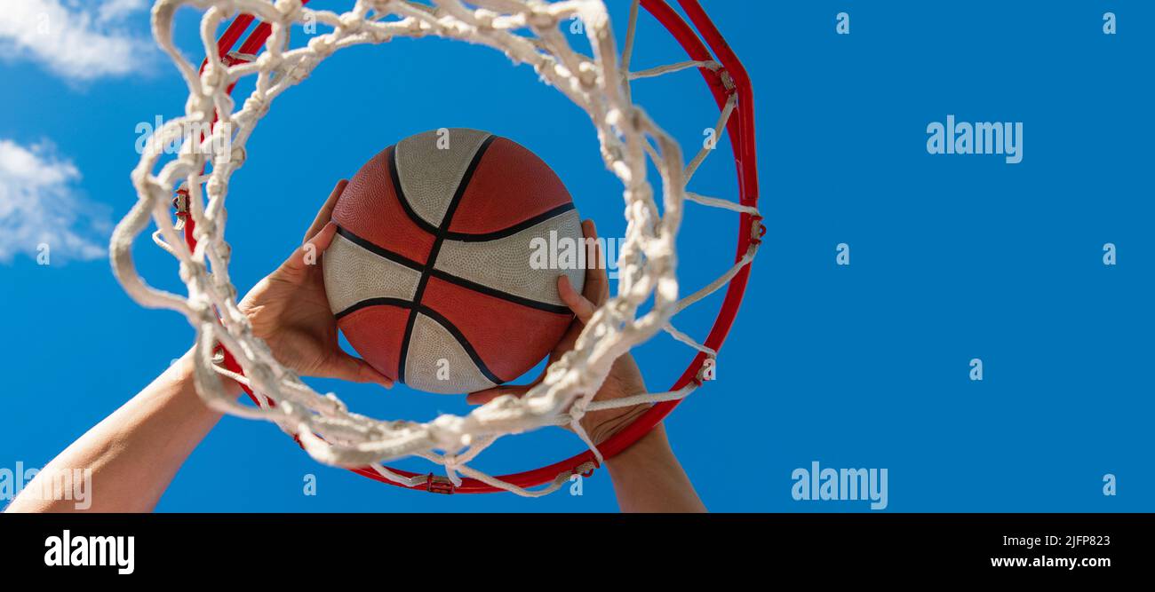 hands of basketball player throws the ball into the hoop, success ...