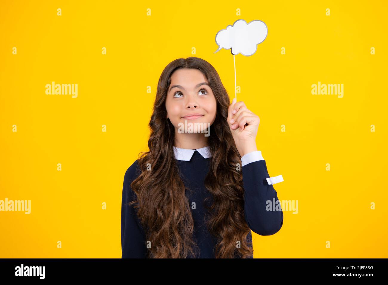 Teenager child girl holding thinking bubble, comment cloud over yellow ...