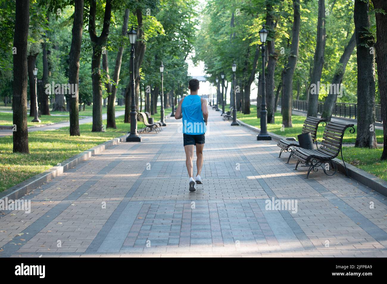 back view of athletic man runner running in sportswear outdoor Stock ...