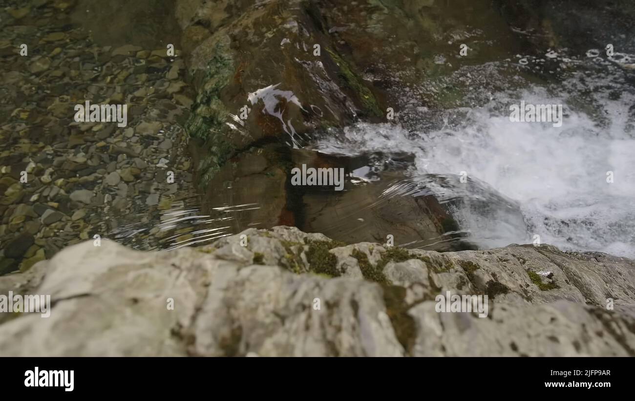 Small waterfall in the river.Creative. Bubbling clear water running ...