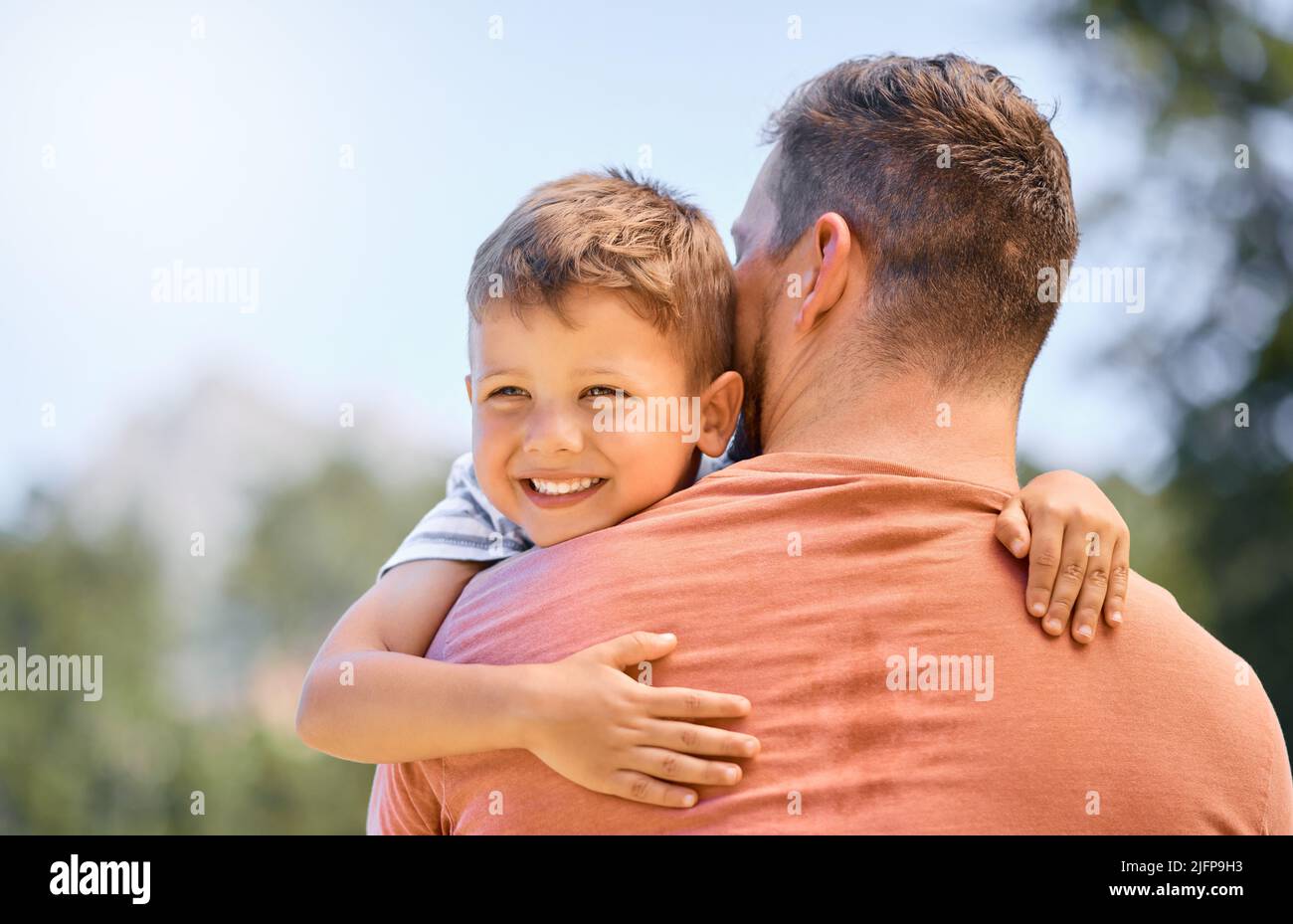 Being with Dad makes him feel the safe and happy. Shot of a little boy ...