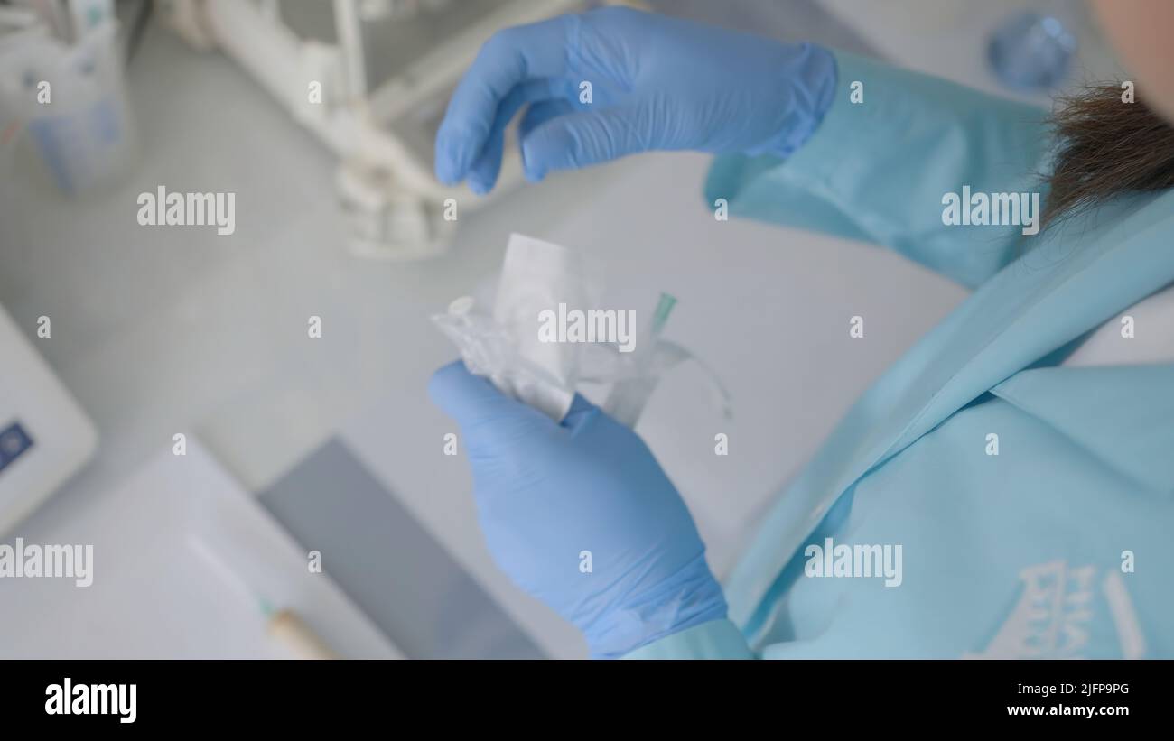 The concept of treatment.Action.A young nurse opens a new syringe and ...
