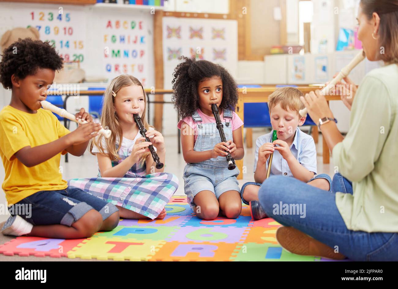 We love learning about musical instruments. Shot of children learning ...