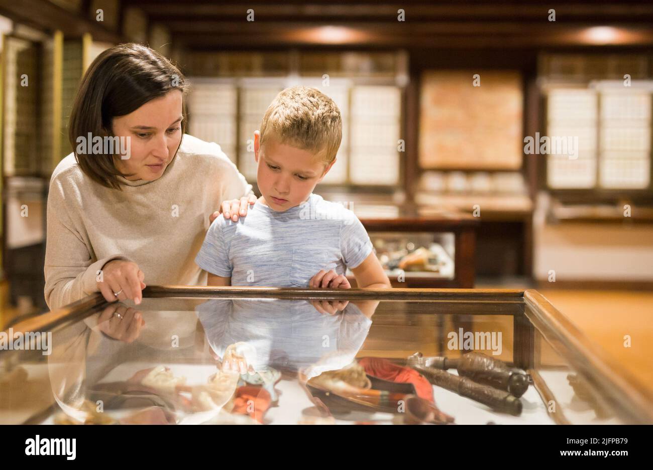 Woman and boy exploring artworks in museum Stock Photo - Alamy