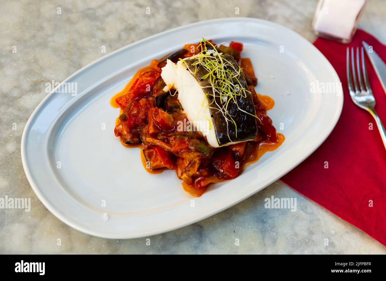 Cod confit with vegetable ratatouille on plate Stock Photo - Alamy
