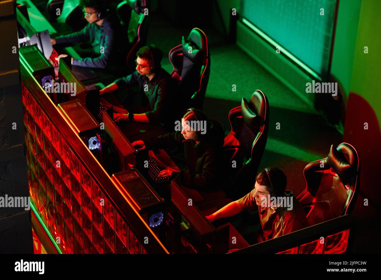 Top view at diverse cybersport team playing video games in row with ...