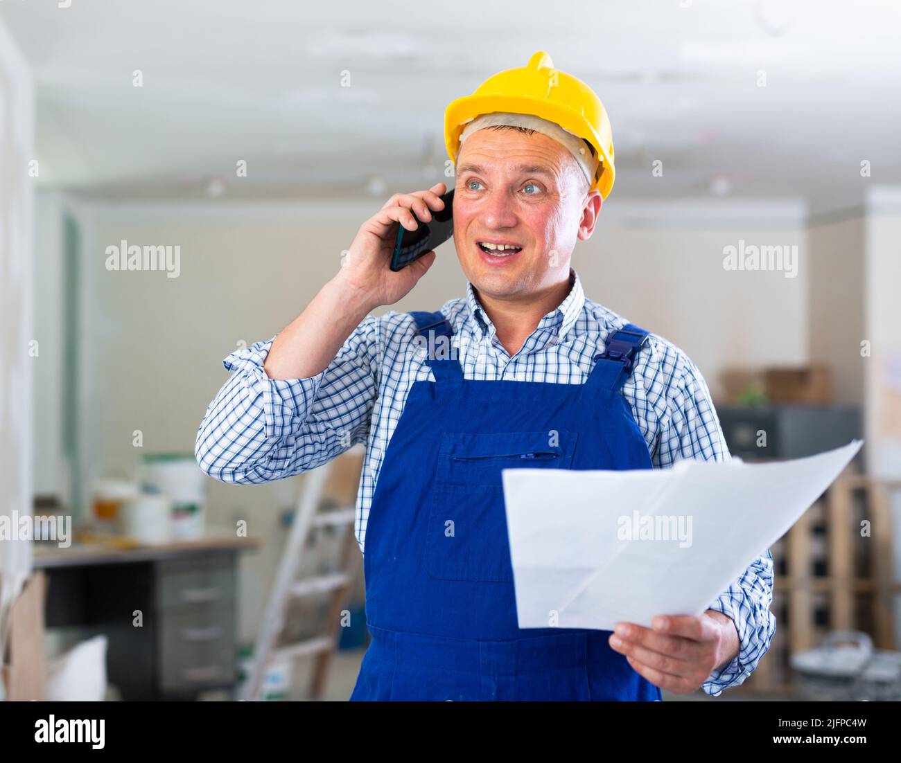 Construction worker having telephone conversation Stock Photo - Alamy