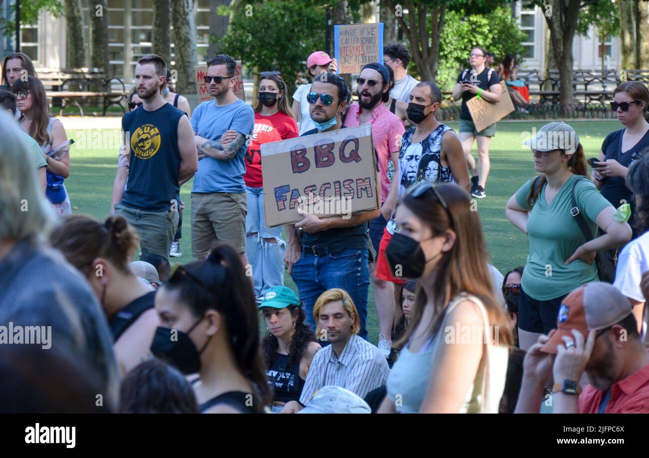 A male participant is holding an anti Fascism sign at Cadman Plaza in ...