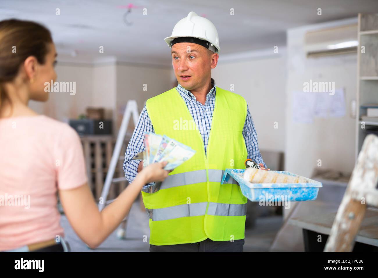 Man house painter getting paid for work Stock Photo - Alamy