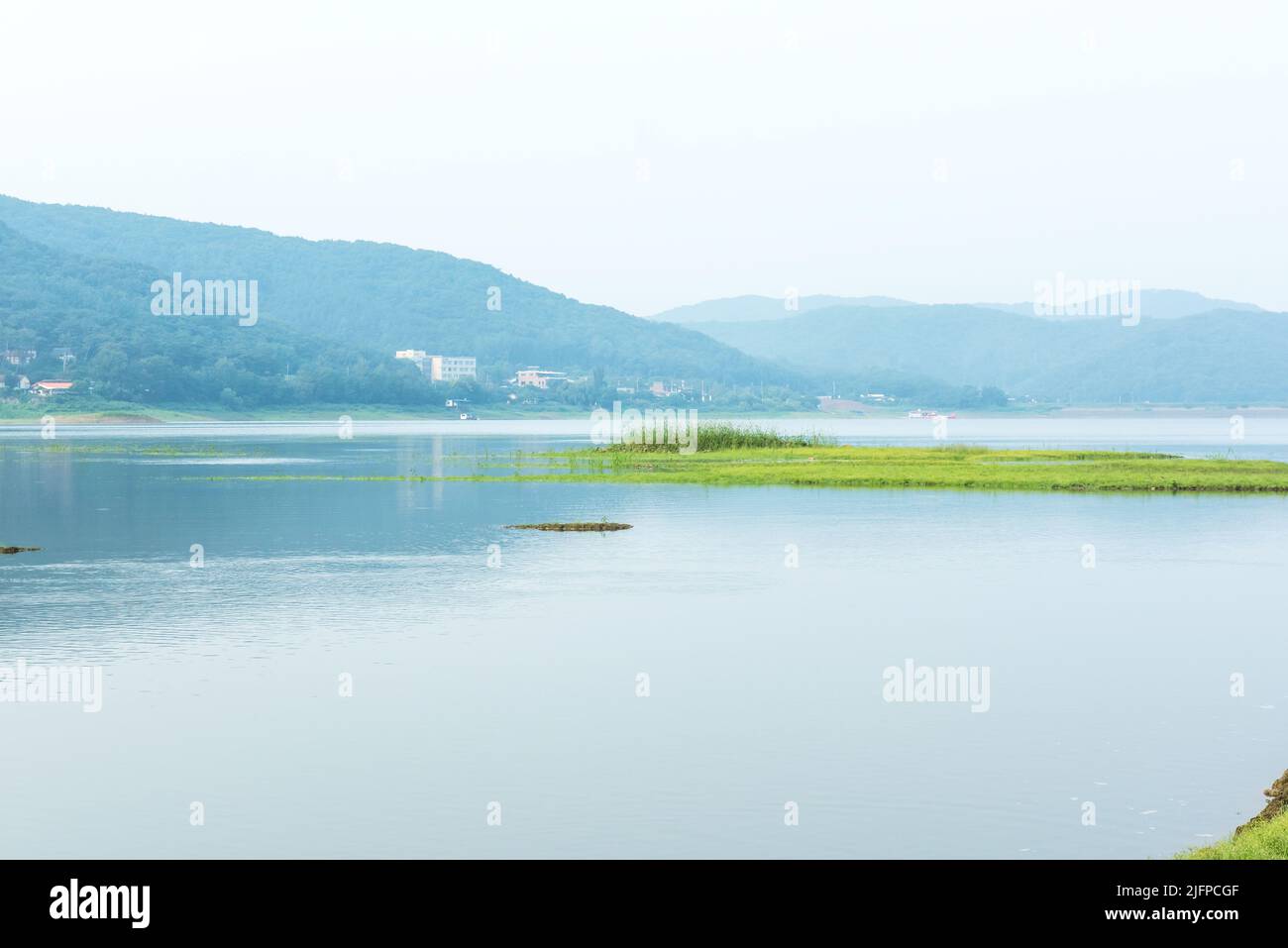 Peaceful and beautiful lake and green field background blue sky,early ...