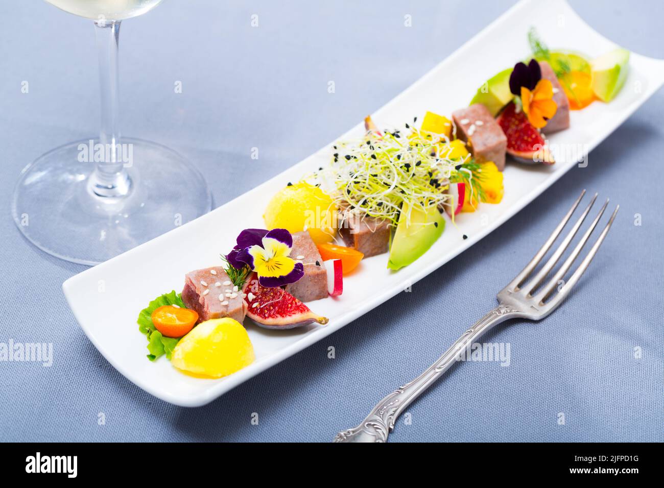 Seared tuna with avocado, mango, figs Stock Photo - Alamy