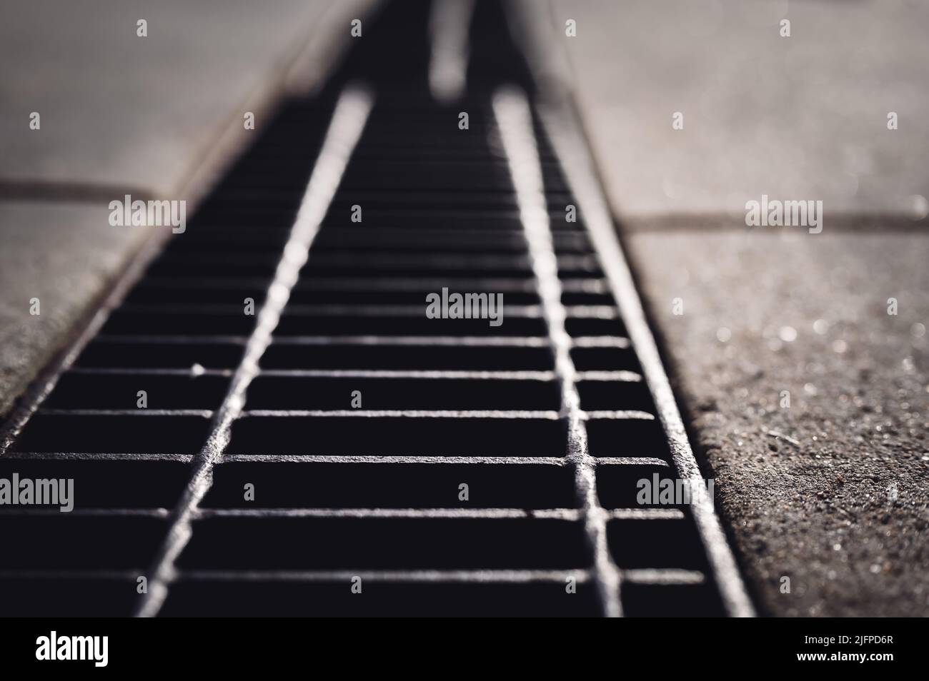 Grate over a stormwater trench in a concrete slab Stock Photo - Alamy