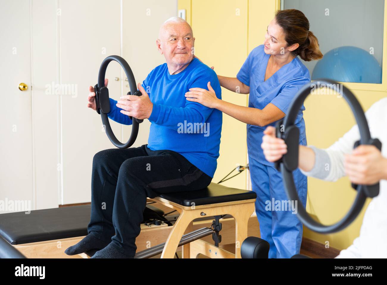 Healthcare professional helps an elderly man restore health with ...