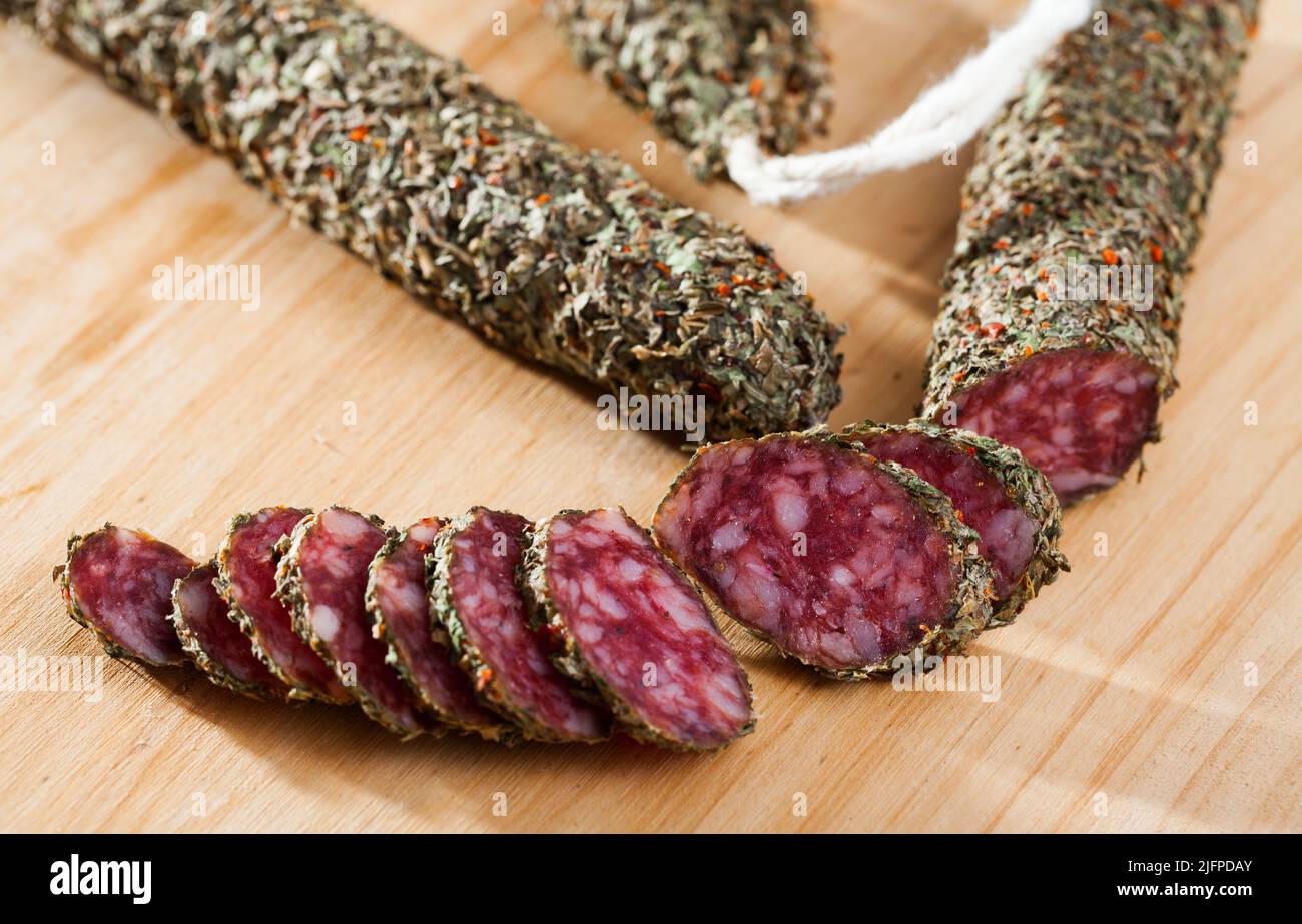 Fuet sausage coated with herbs Stock Photo - Alamy