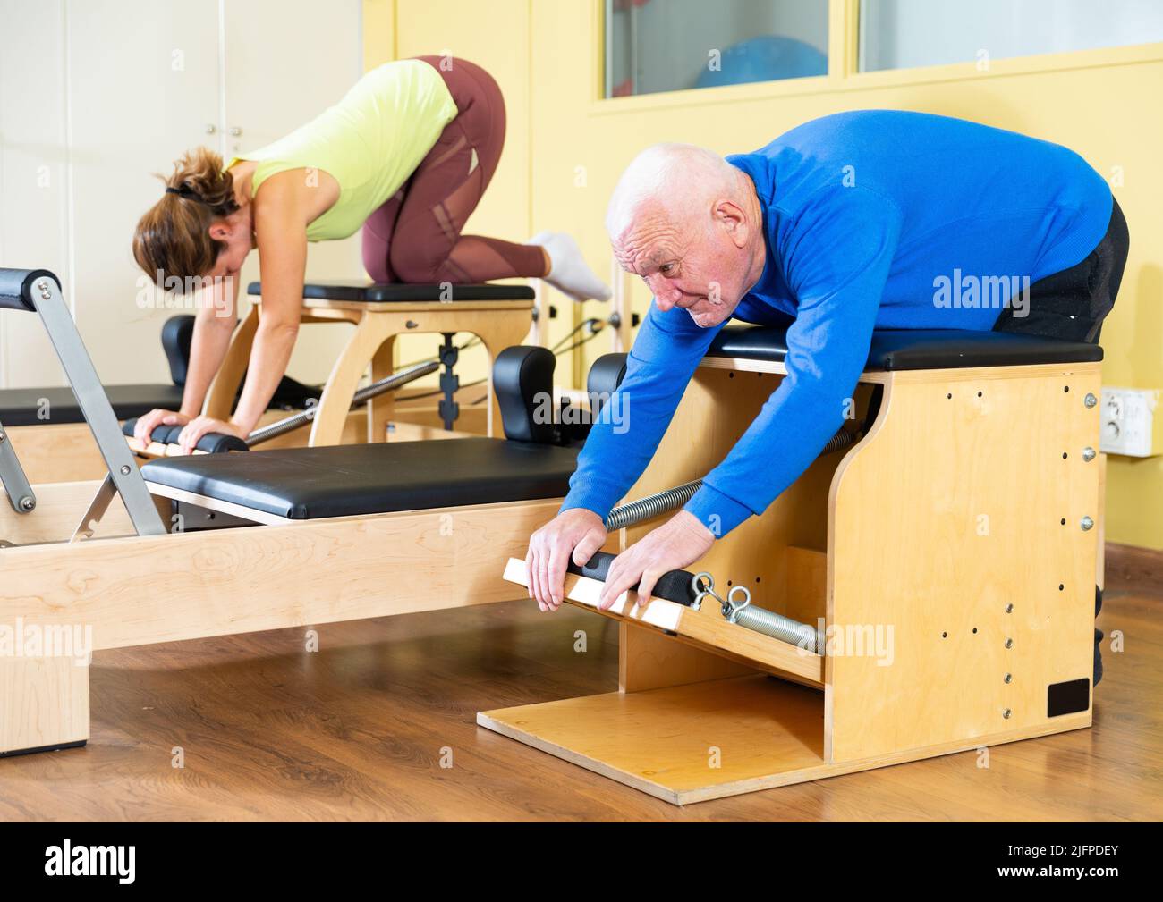 Elderly man press exercises on pilates reformer at studio Stock Photo ...