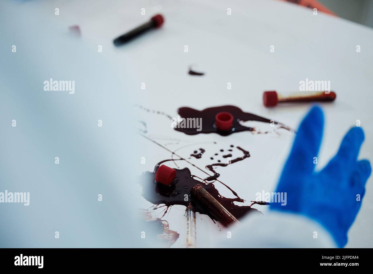 Things have gotten messy. Shot of an unrecognizable scientist cleaning ...