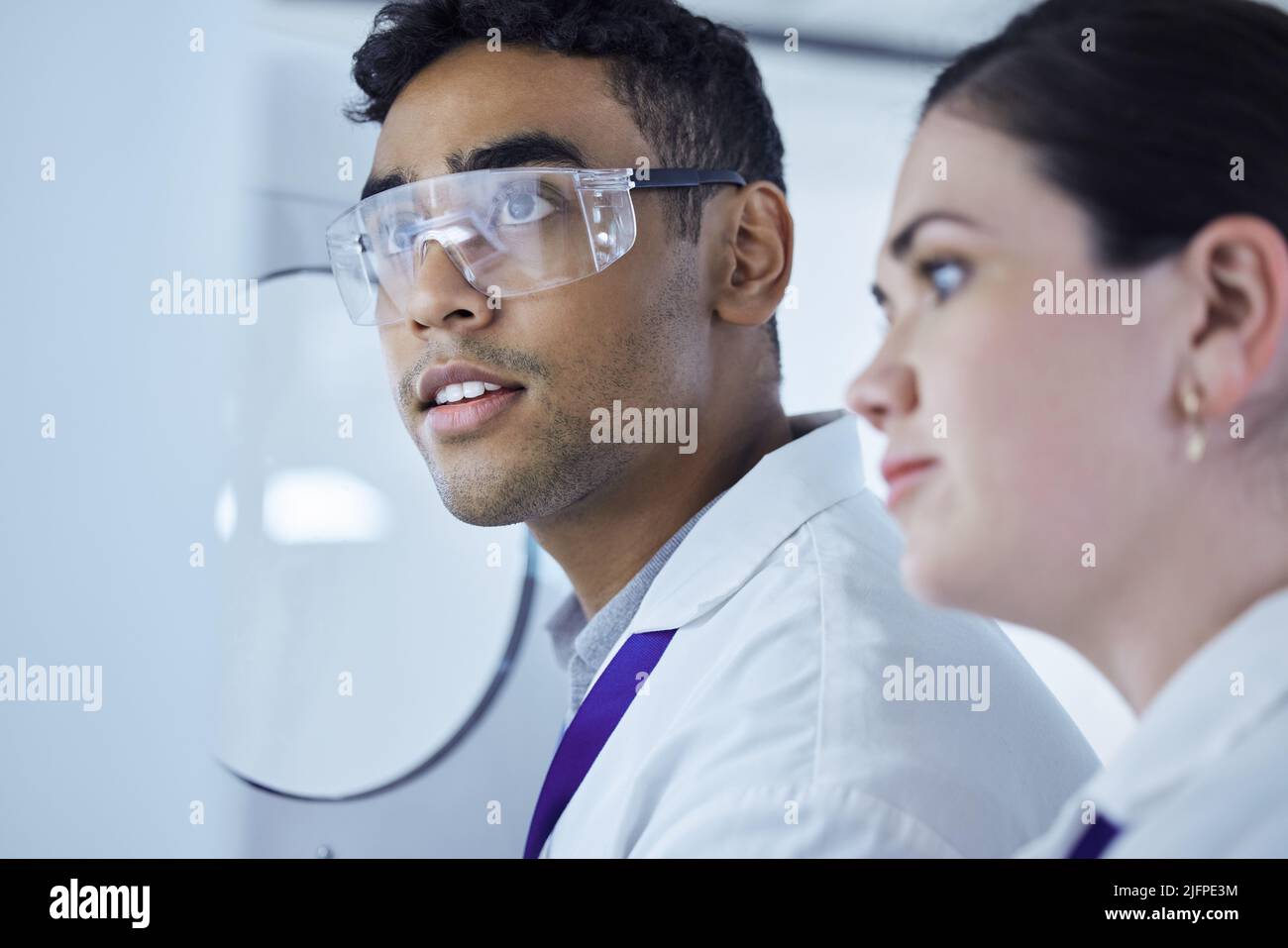 One step away from a miracle. Shot of two lab workers removing samples ...