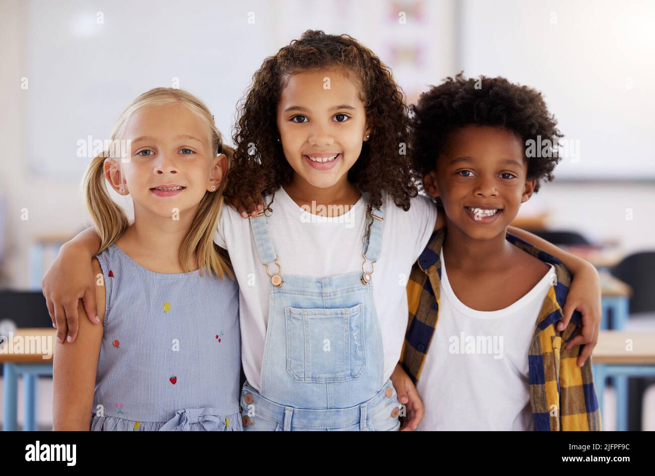 Learning new things. Shot of three preschool students standing together ...