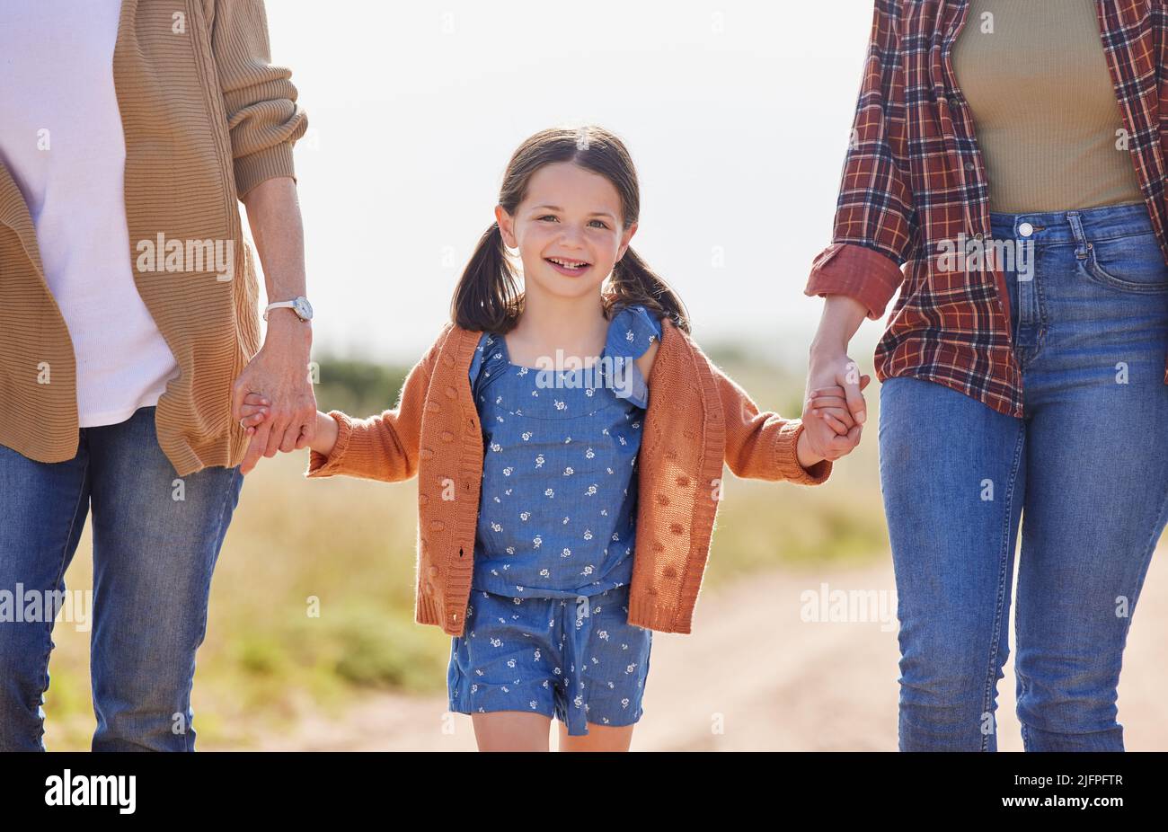 My parents are farmers. Shot of a little girl walking on a farm with ...