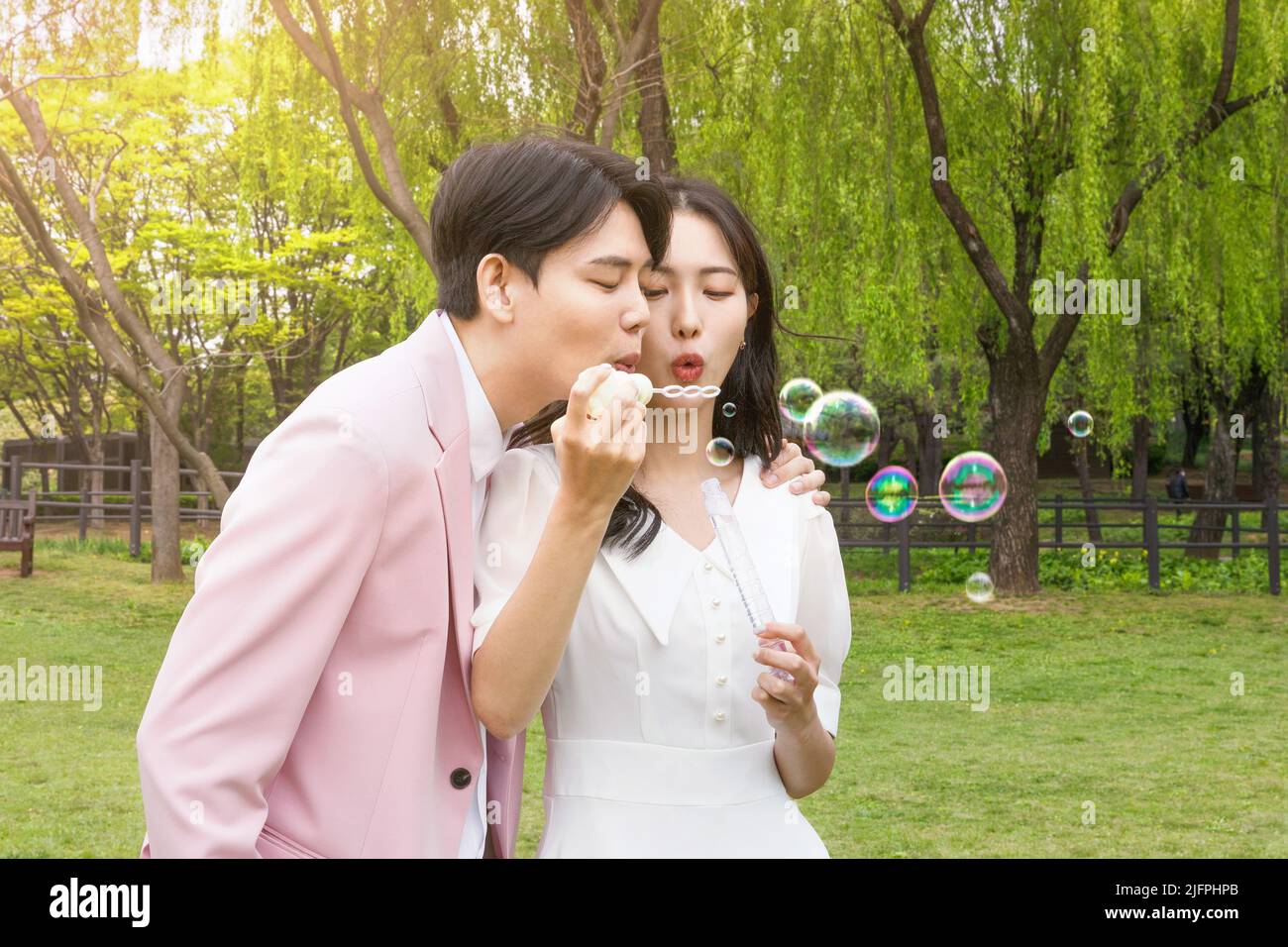 Korean Asian couple self small wedding concept in spring blowing soap ...