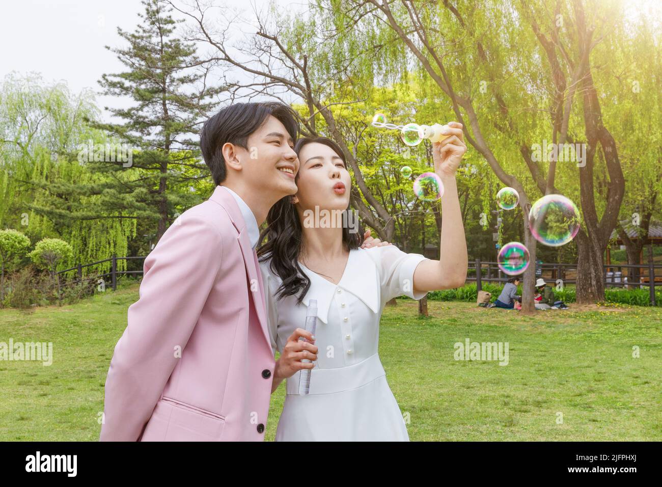 Korean Asian couple self small wedding concept in spring blowing soap ...