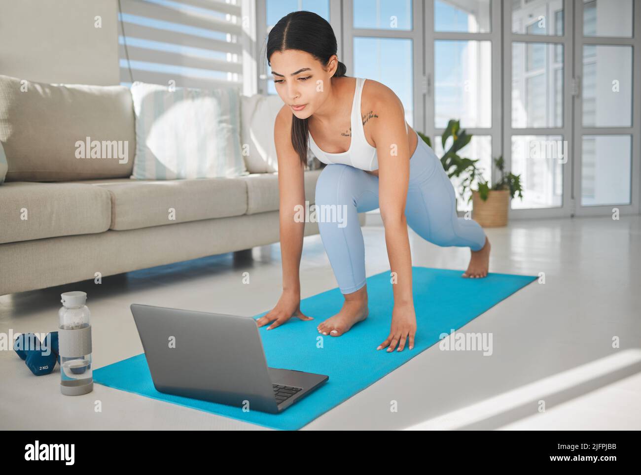 Virtual workouts are great to do in your own time. Shot of a sporty ...