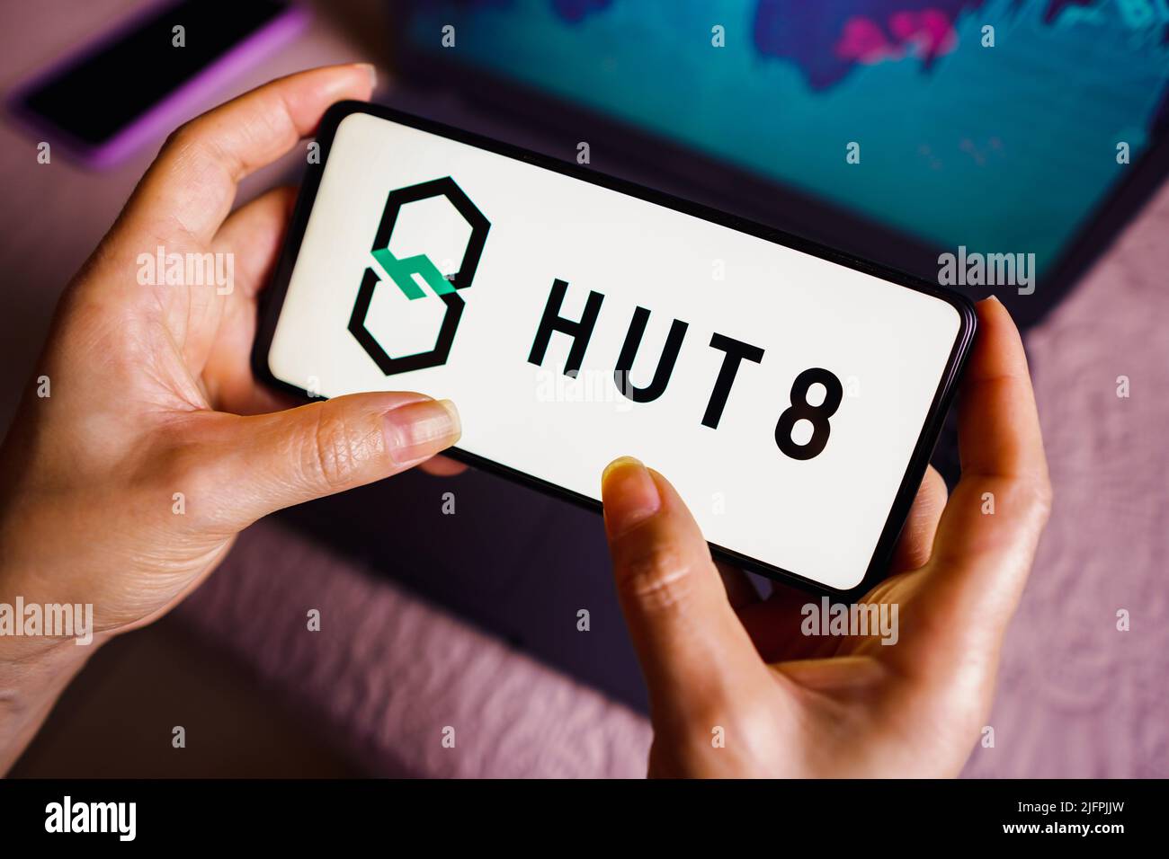 In this photo illustration, the Hut 8 Mining logo seen displayed on a ...