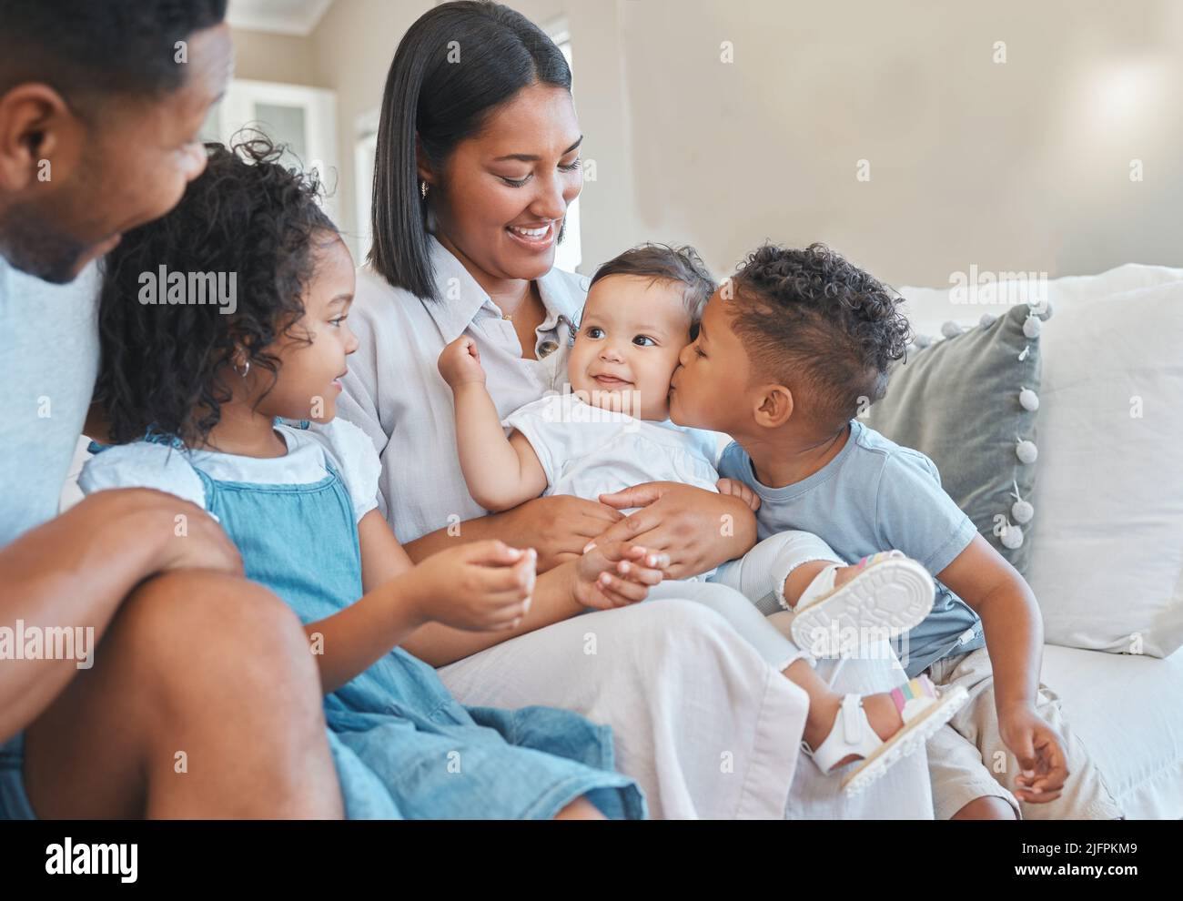 Our family is has grown. Shot of a young family happily bonding ...