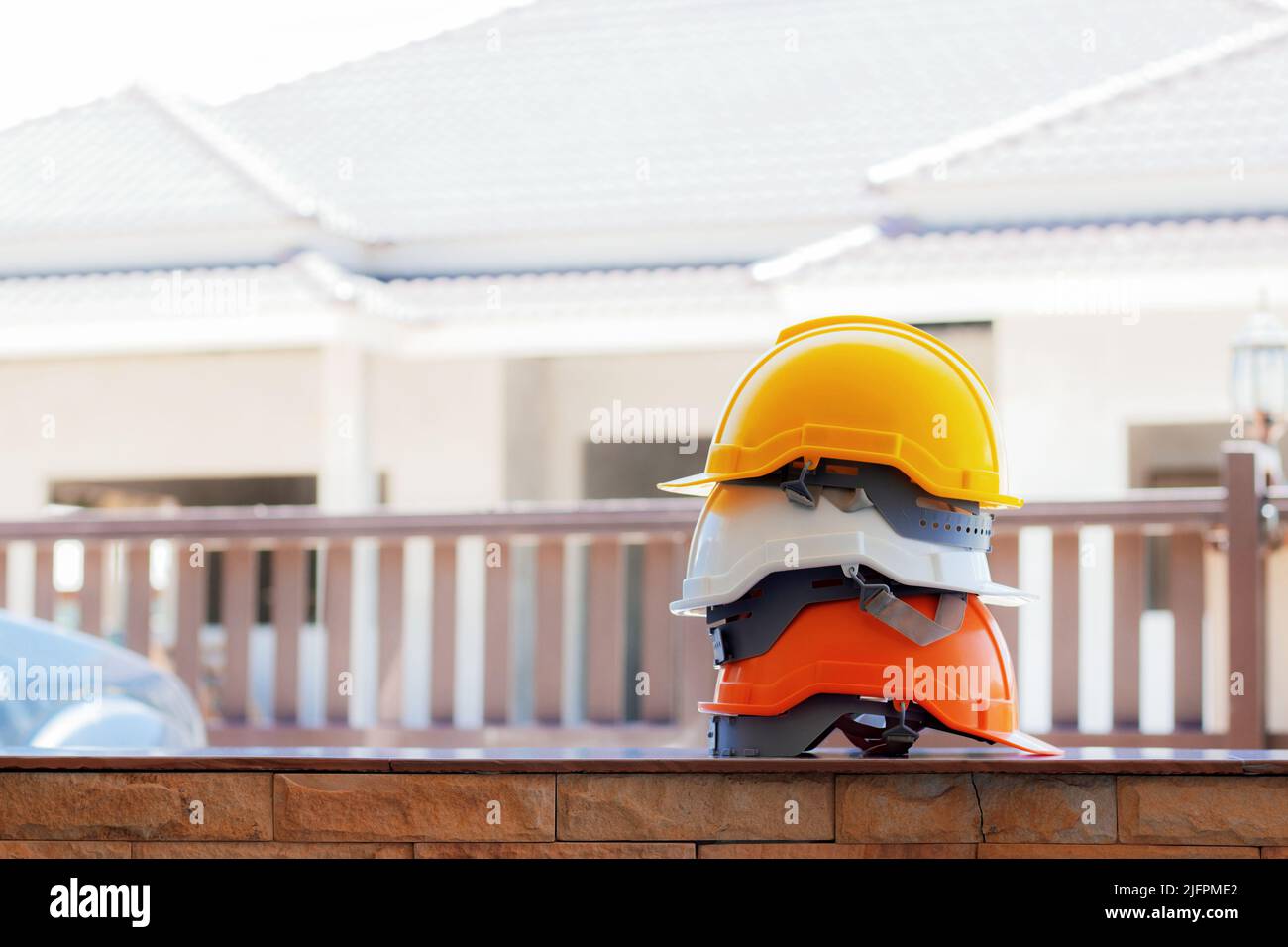 Hat for construction on tile with house background Stock Photo - Alamy