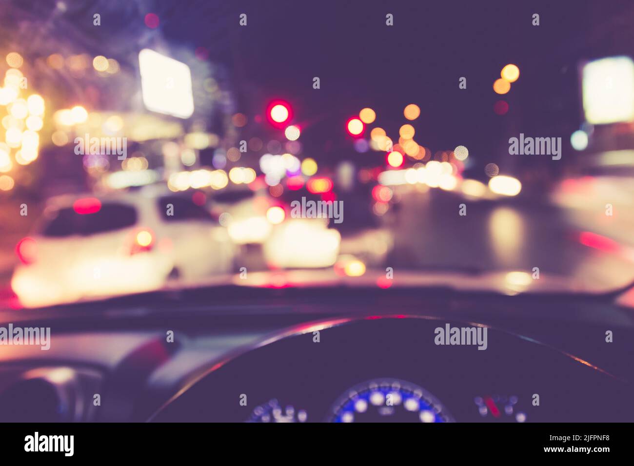Blur image of inside cars with bokeh lights from traffic jam on night ...