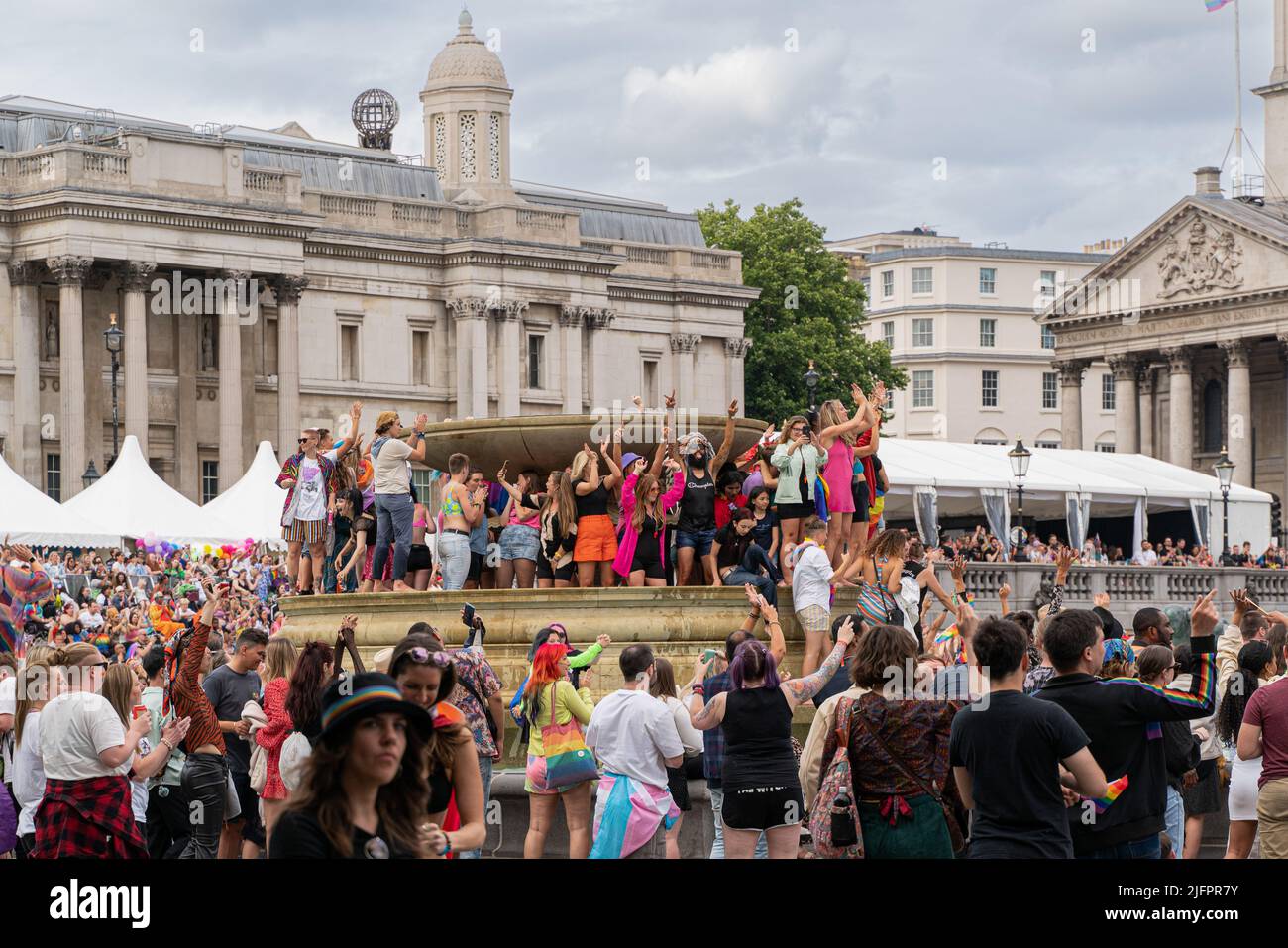 Pride participants enjoy themselves by partying on fountains in ...