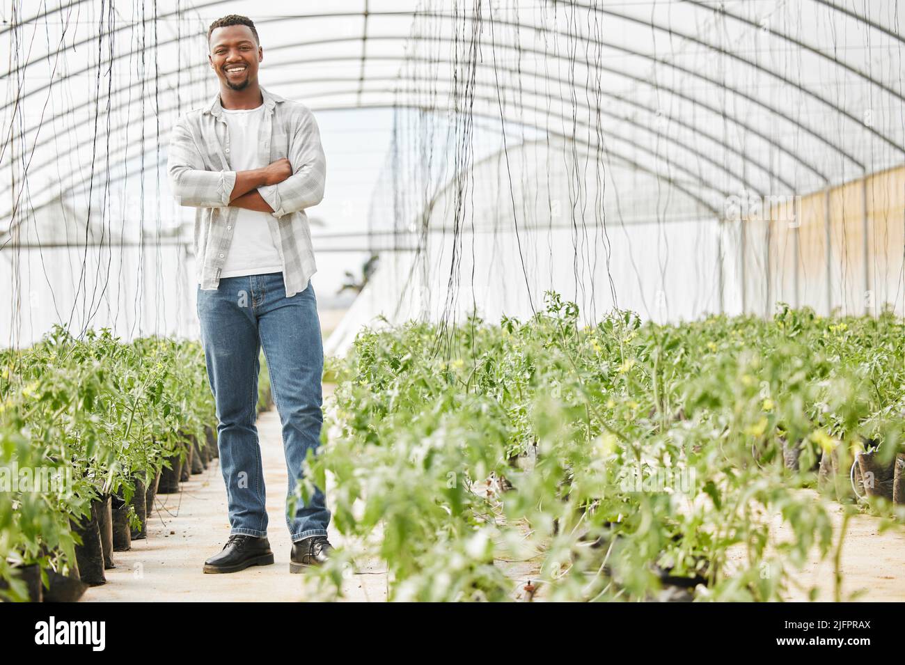 My farm is growing. Full length shot of a handsome young man working on ...