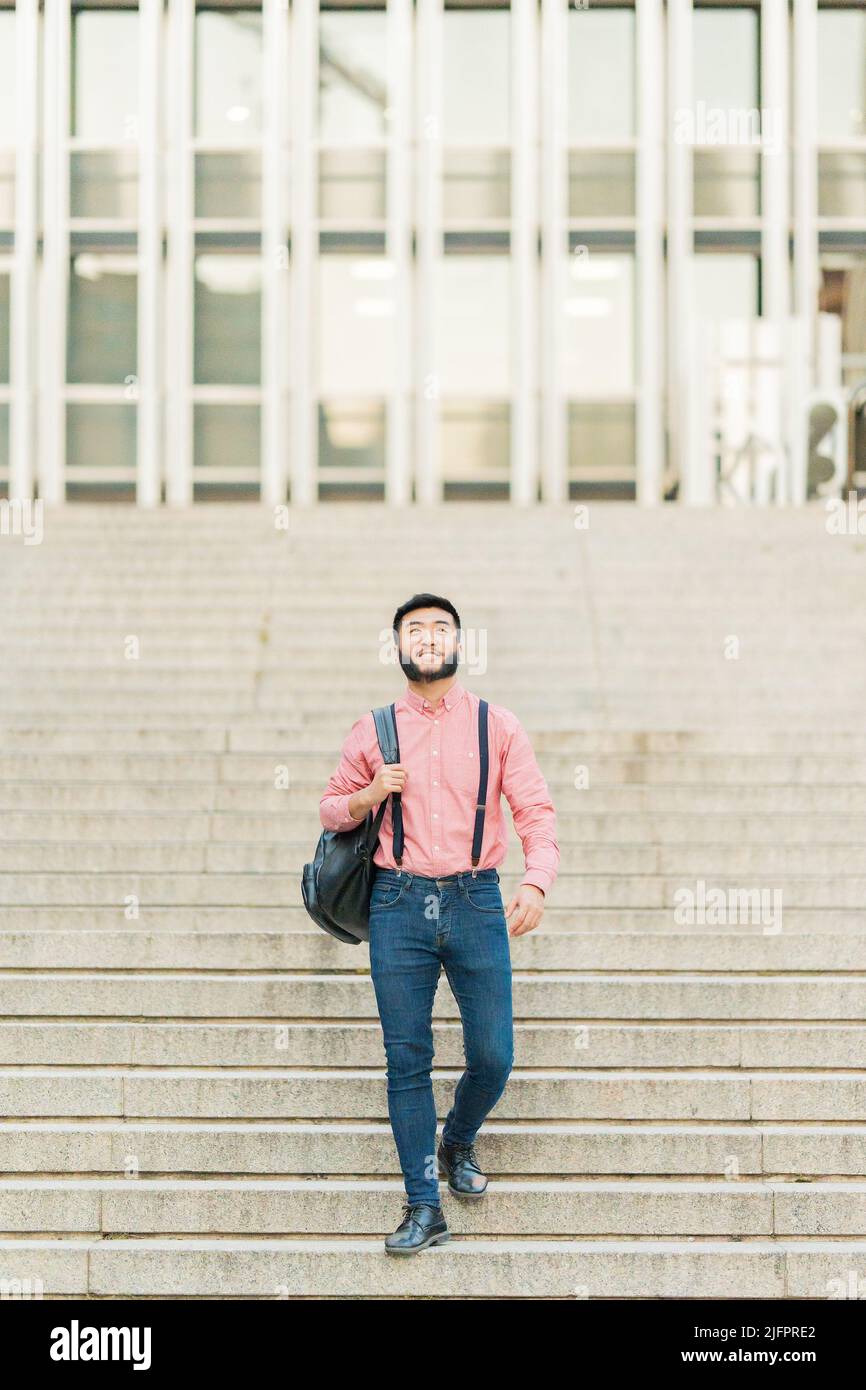 Chinese man walking down a stairs in a city Stock Photo - Alamy