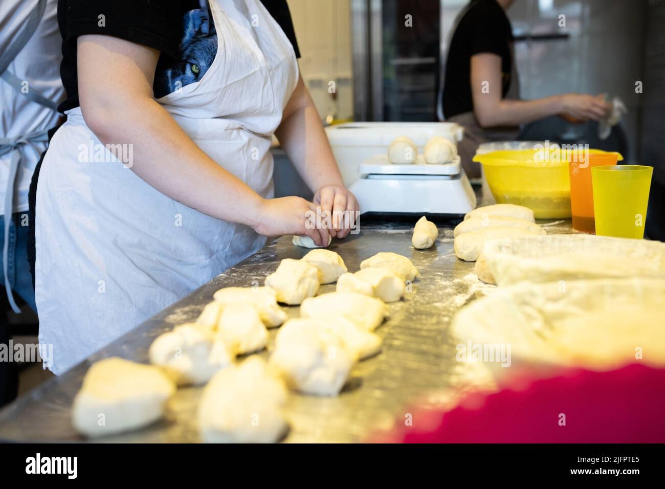 The process of making bread. Dividing the wheat dough into pieces for ...