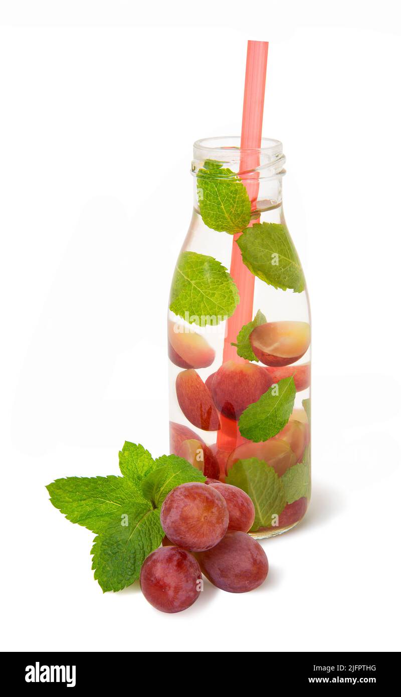 Cold fresh detox beverage of red grapes, mint leaves, water in glass ...