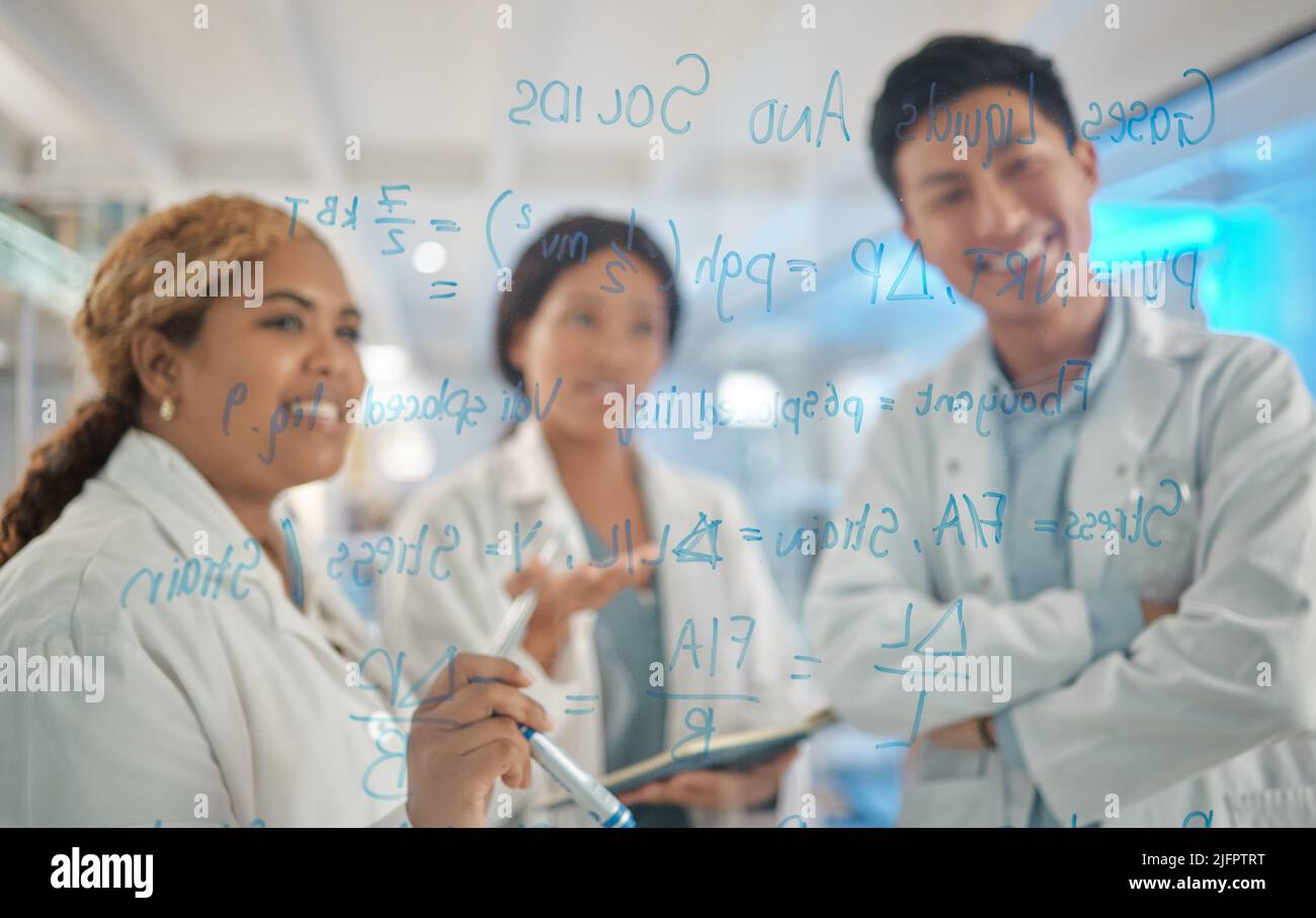 Planning how to achieve their success. Shot of a group of lab workers ...